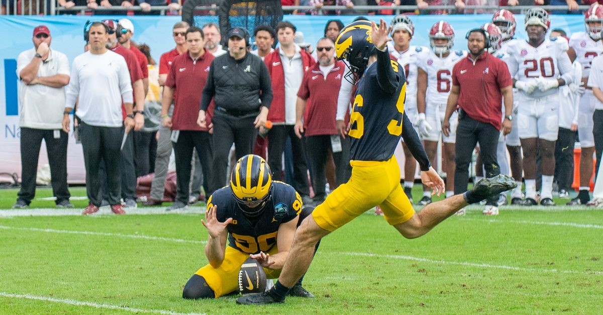 Handing out game balls after Michigan’s upset victory over Alabama