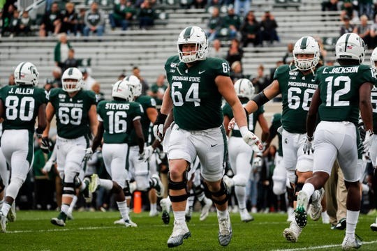 Michigan State football players find out brothers come in handy in workouts
