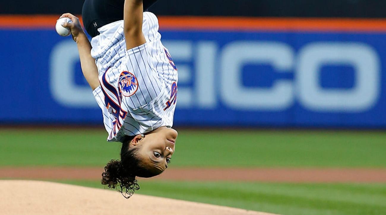 Olympic gymnast Laurie Hernandez cartwheels into a ceremonial first pitch
