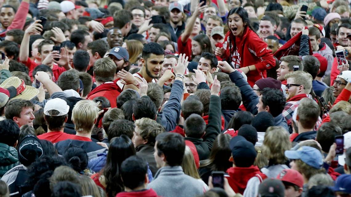 NC State fans storm the court after victory over Duke